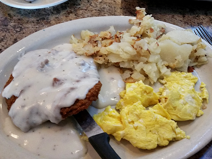 Country-fried steak smothered in gravy alongside golden home fries and fluffy eggs&mdash;the breakfast equivalent of a warm hug.