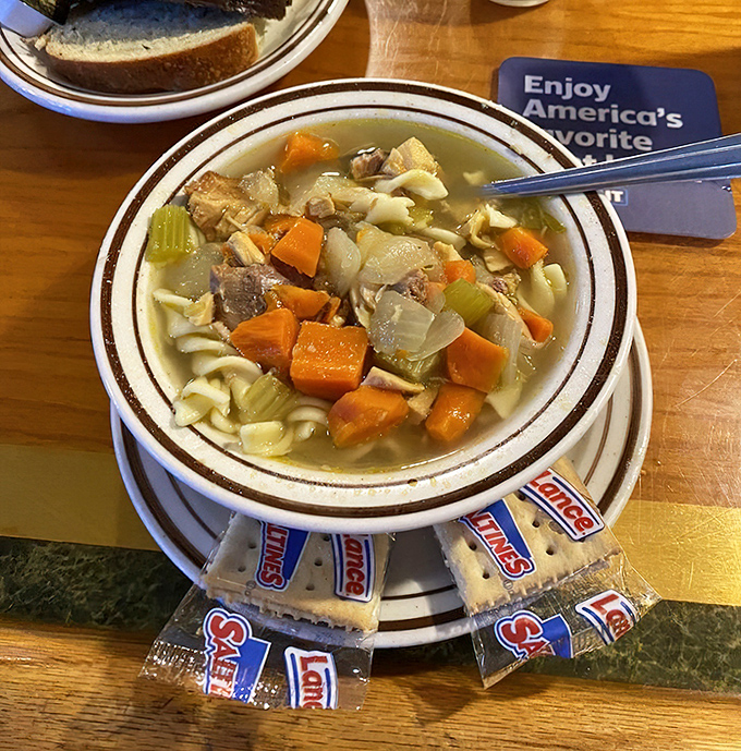This isn't just chicken noodle soup; it's liquid comfort served with a side of crackers and childhood memories.