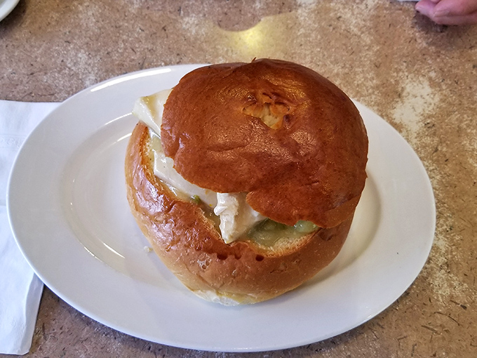 This golden-brown sandwich on a brioche bun isn't just lunch—it's edible architecture with layers of deliciousness waiting to be discovered.