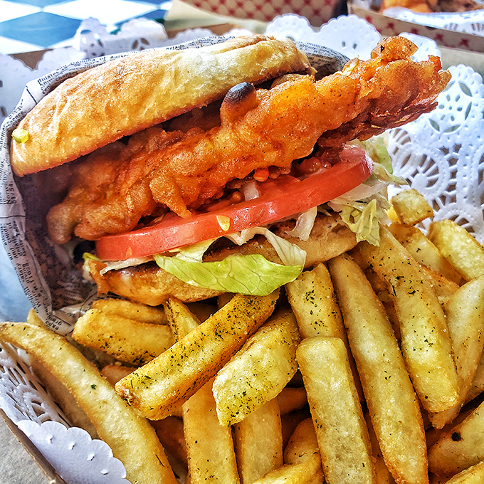 This isn't just a sandwich; it's an architectural masterpiece of crispy chicken, fresh veggies, and pillowy bread that requires both hands and napkins.