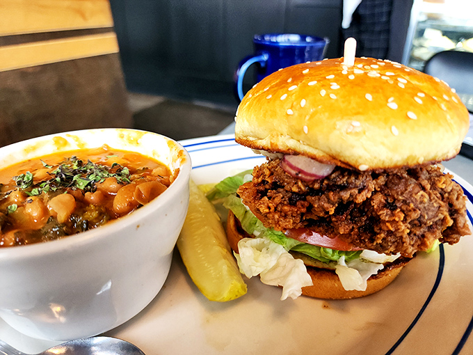 This isn't just a sandwich; it's architecture. The crispy chicken creation stands tall beside a soup that's clearly not from any can.