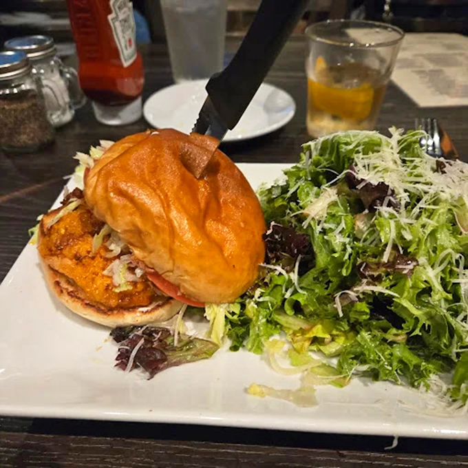 Not your average chicken sandwich—this beauty comes with a side of fresh greens that makes you feel virtuous while committing delicious sins.