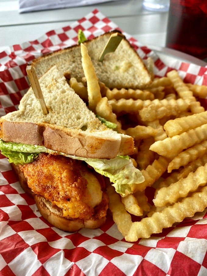 The chicken sandwich that launched a thousand cravings, served with crinkle-cut fries on classic red-and-white checkered paper.