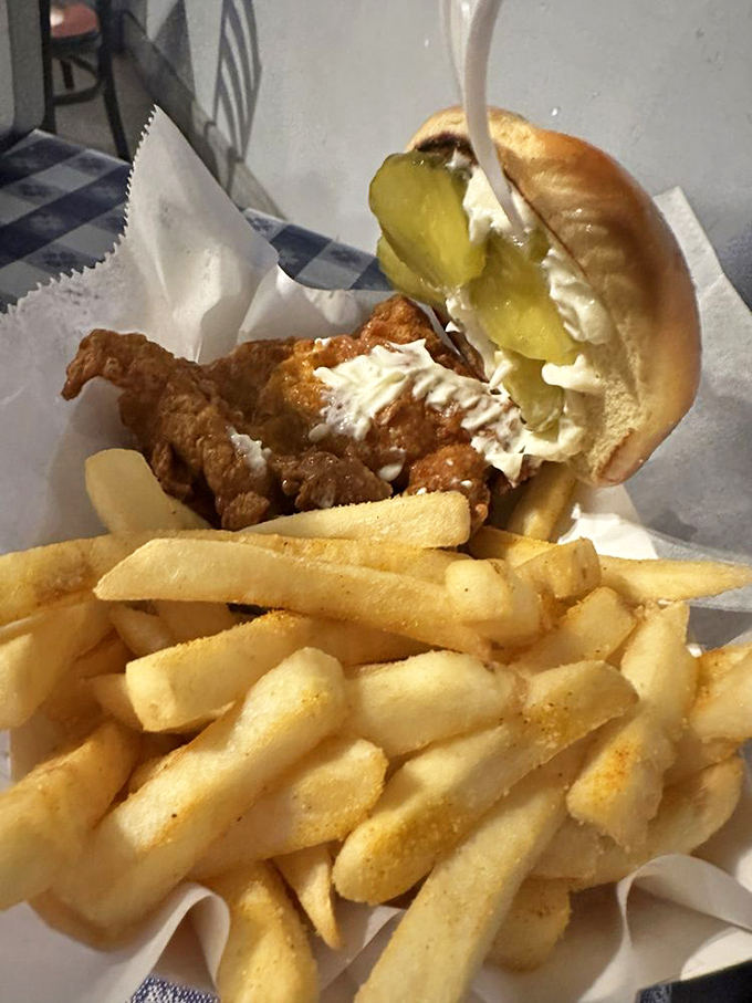 The chicken sandwich – where crispy, juicy perfection meets pillowy bun. Those pickles aren't just garnish; they're the tang ambassadors cutting through the richness.