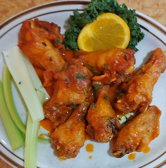 Buffalo wings that don't need a sports bar to shine. That vibrant sauce clings to each wing like it's afraid of missing the flavor party.