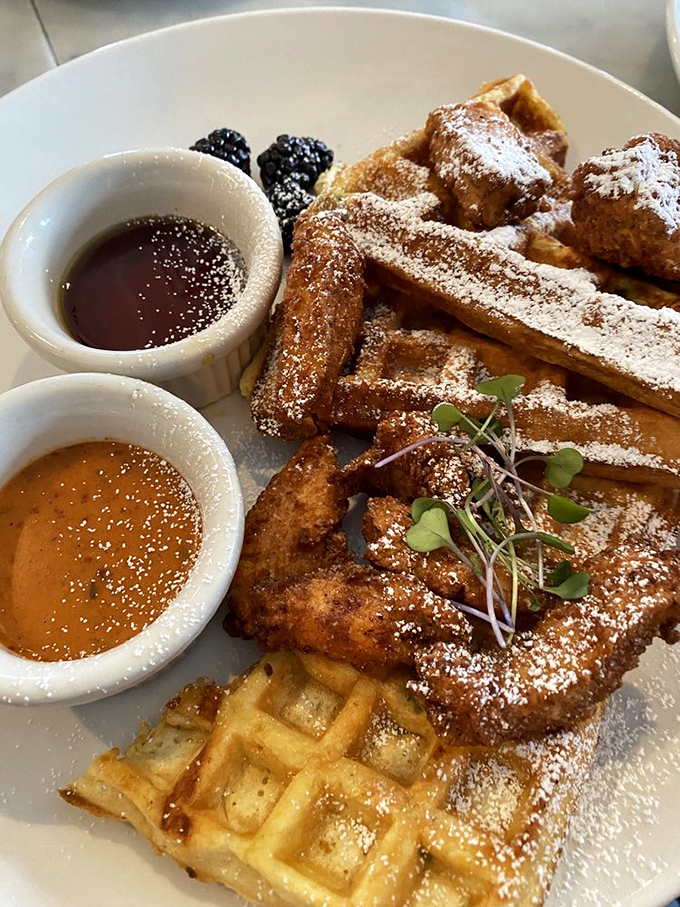 Chicken and waffles: where breakfast and dinner had a beautiful baby. That maple syrup and powdered sugar dusting is pure morning magic.