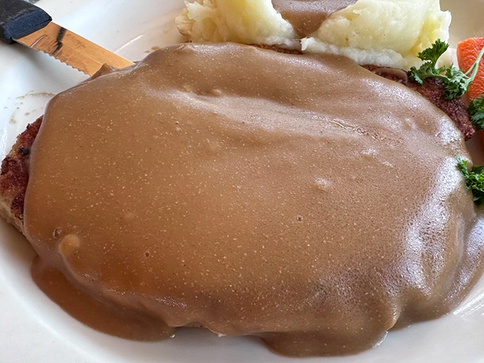 Chicken fried steak swimming in gravy—the kind of honest, hearty plate that makes you wonder why anyone bothered inventing molecular gastronomy.