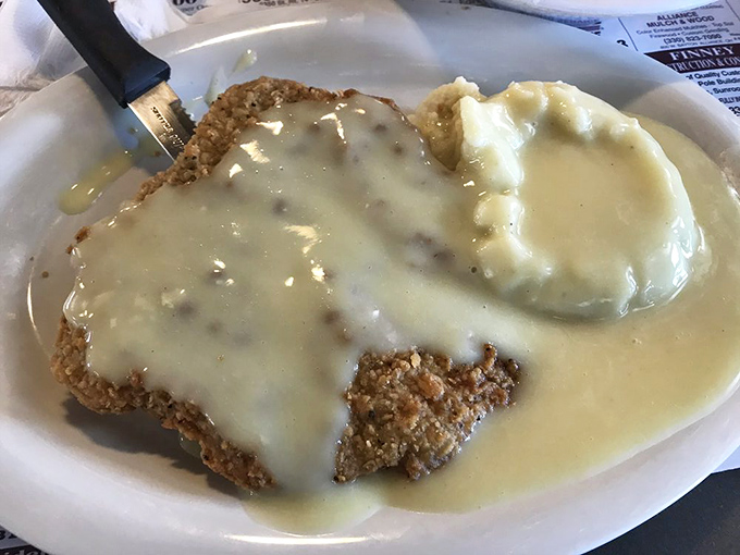 Chicken-fried steak swimming in creamy gravy alongside fluffy mashed potatoes &ndash; comfort food that whispers, &lsquo;Take a nap after this, you&rsquo;ve earned it.&rsquo;