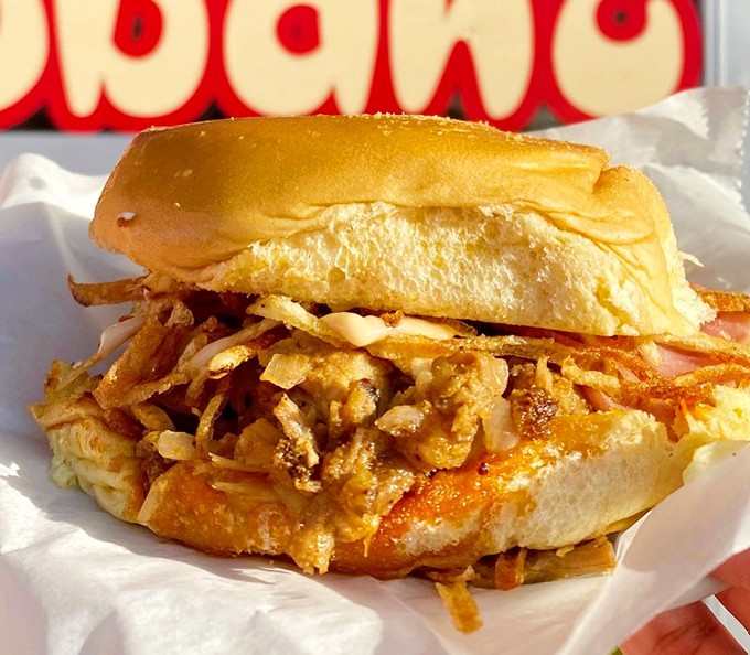 This isn't just a sandwich, it's architecture&mdash;layers of flavor stacked between soft Cuban bread with those signature crispy potatoes spilling out everywhere.