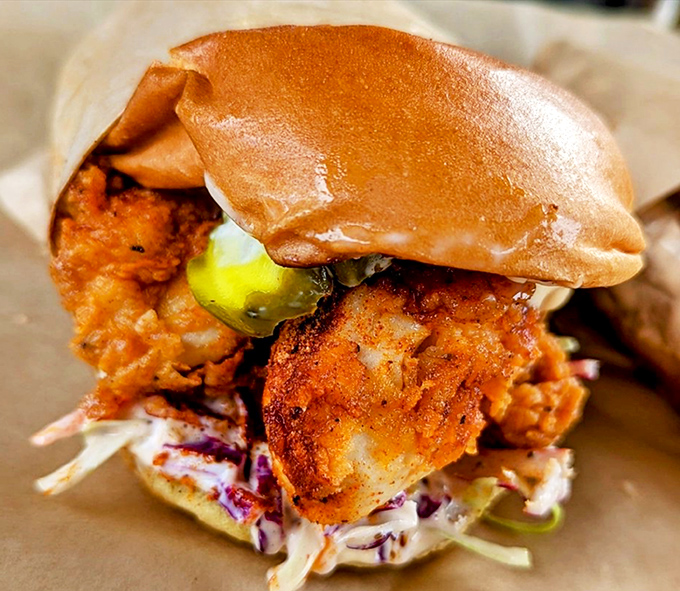 A sandwich that requires both hands and your full attention. The crispy chicken peeks out like it's showing off for the camera.