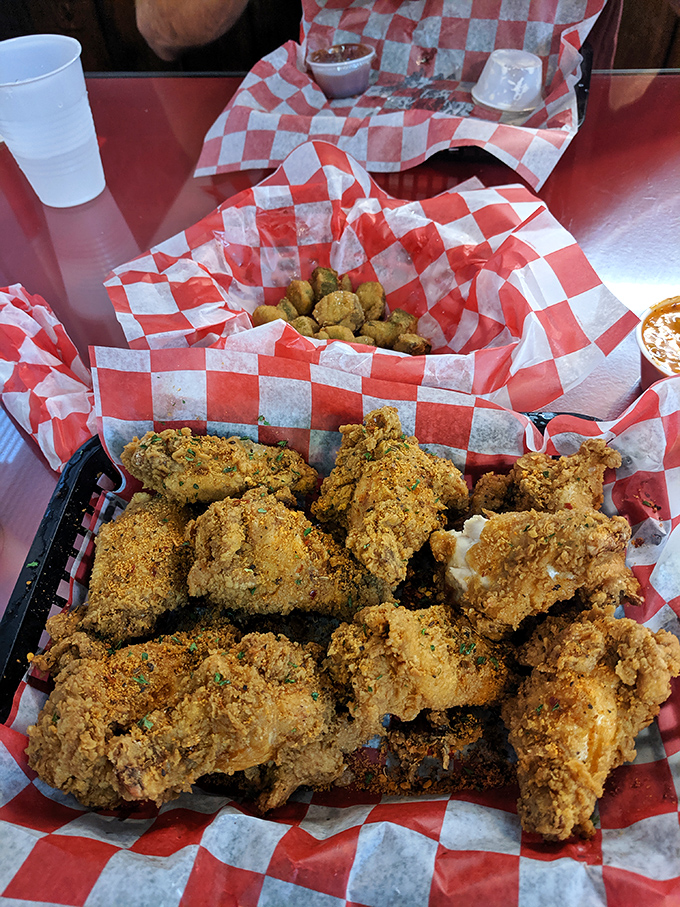 These golden-brown beauties aren't just chicken wings&mdash;they're crispy vessels of joy served in classic red-and-white checkered paper boats.