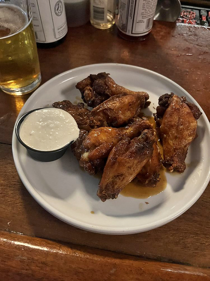 Wings that make you wonder why we ever bothered inventing forks. Crispy, saucy perfection that demands to be eaten with your hands and zero shame.