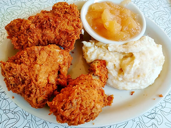 Southern comfort that crunches. This fried chicken achieves that mythical balance of crispy exterior and juicy interior that would make your grandmother both jealous and proud.