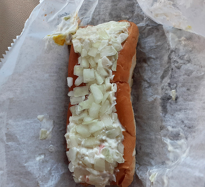 This slaw dog isn't just a meal&mdash;it's a Southern handshake in food form, with crisp onions standing at attention atop creamy slaw.