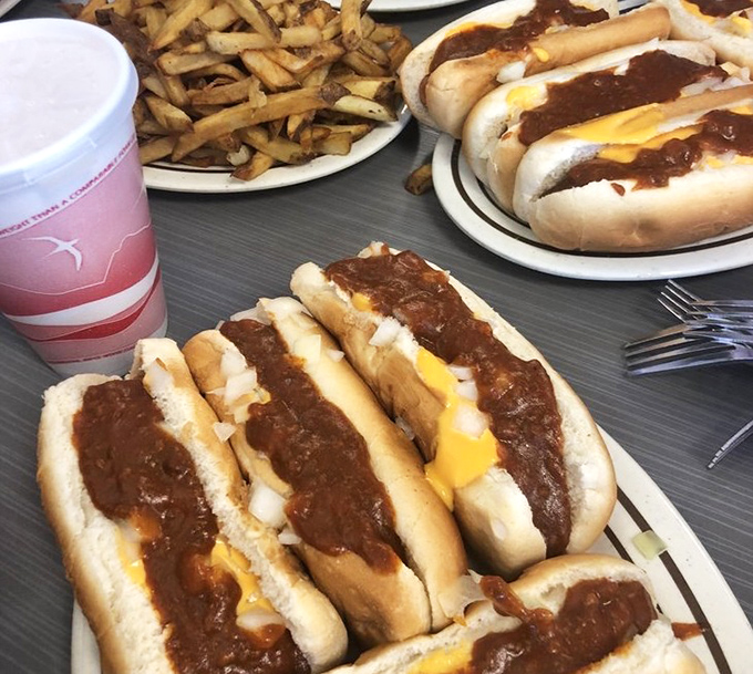 The holy trinity of hot dog perfection: savory chili, melted cheese, and a perfectly steamed bun. Napkins required, regrets impossible.