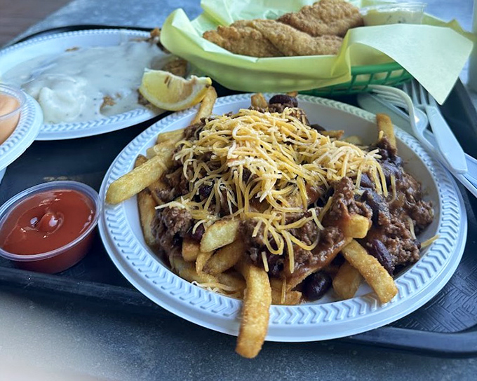 Fries living their best life under a blanket of chili and cheese. This isn't a side dish&mdash;it's a commitment to happiness that requires both a fork and napkins.