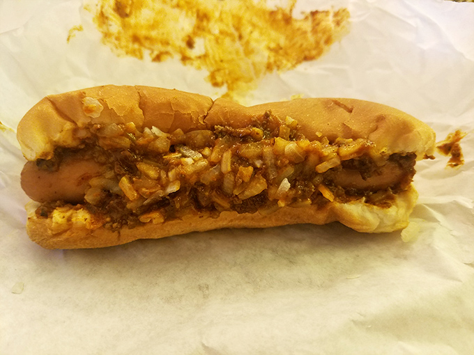 Not just any hot dog—a proper Midwest chili dog with all the fixings. The kind that requires strategic eating and extra napkins.