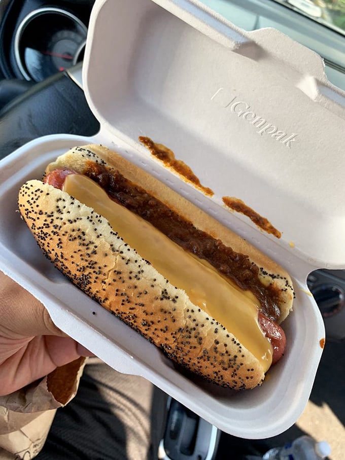 The poppy seed bun cradles this chili cheese dog like it was born for this purpose. A portable feast that demands both napkins and respect.