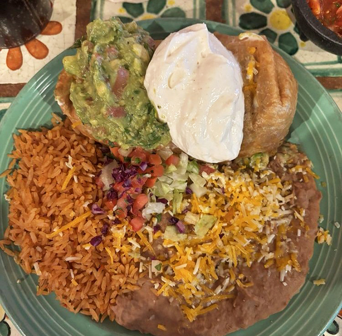 This chimichanga isn't just dinner&mdash;it's architecture. A perfectly crisp exterior giving way to tender filling, topped with guacamole that's practically glowing with freshness.