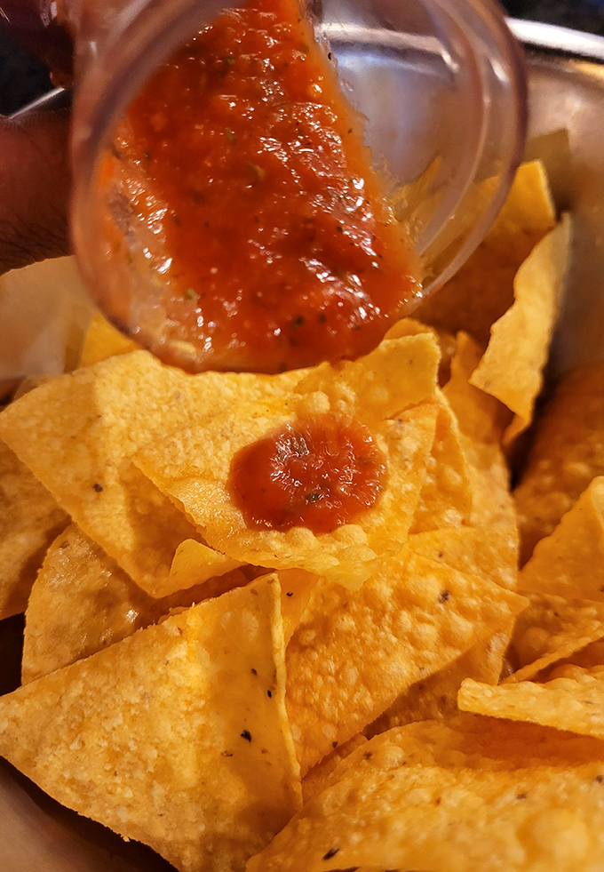 That moment when fresh salsa cascades onto crispy homemade chips&mdash;a simple pleasure that somehow makes everything right with the world.