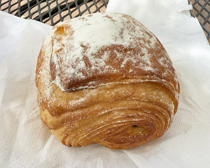 Layers upon buttery layers of pastry perfection. This powdered sugar-dusted croissant isn't just breakfast&mdash;it's a religious experience worth setting an alarm for.