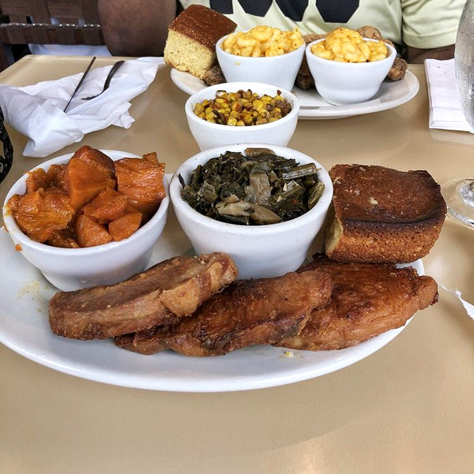 Pork chops and collard greens sharing a plate with mac and cheese and candied yams &ndash; a quartet that performs perfect Southern harmony.