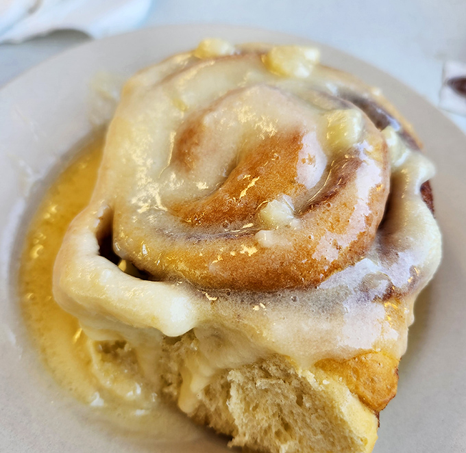 That cinnamon roll isn't just breakfast&mdash;it's dessert masquerading as a morning meal, glistening with icing that's practically winking at you.