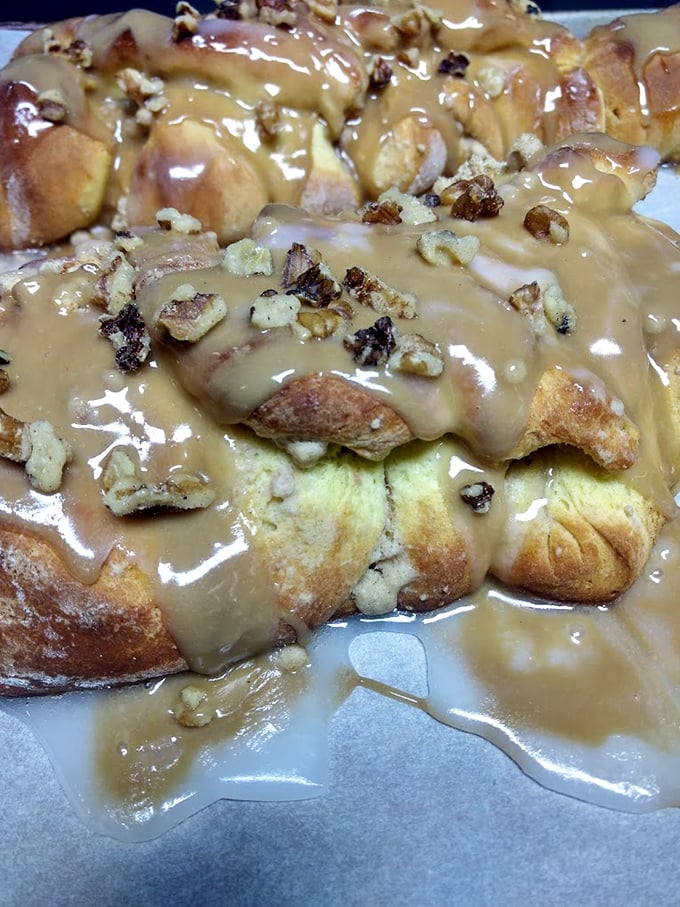 This isn't just a cinnamon roll&mdash;it's a caramel-drenched, pecan-studded monument to morning indulgence that demands to be photographed before it's devoured.