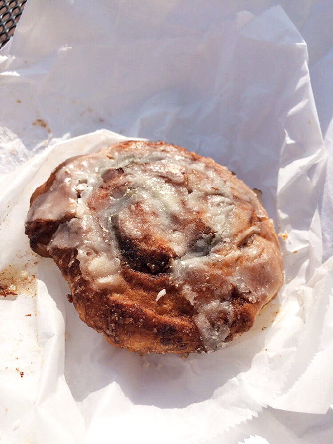 The cinnamon roll glistens with sweet glaze, offering a perfect counterpoint to savory breakfast options and proving Sunrise excels beyond just biscuits.