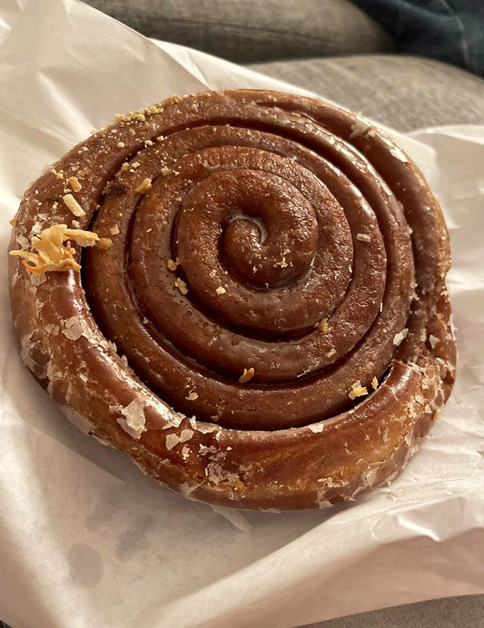 This cinnamon roll isn't just breakfast; it's an architectural marvel of spiraling dough and crystallized sugar that demands respect with every bite.