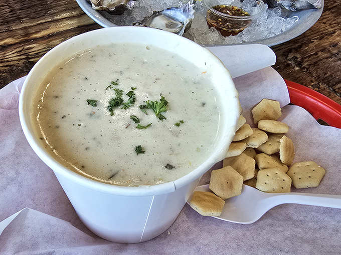 The holy grail of coastal comfort: creamy clam chowder with tender clams and herbs, served with oyster crackers that are basically tiny shovels for maximum chowder delivery.