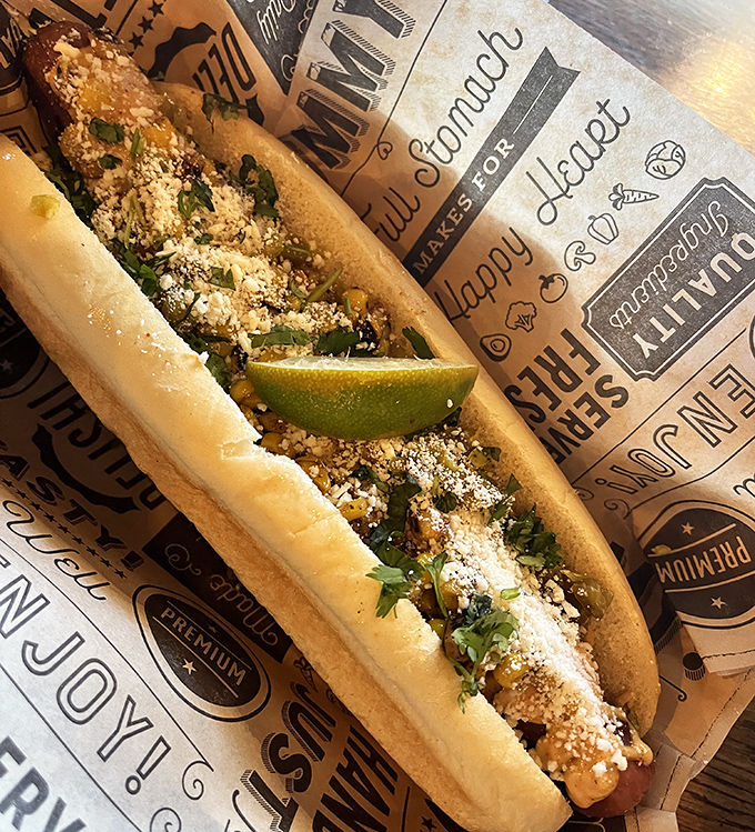 This isn't just a hot dog&mdash;it's a canvas of culinary creativity with cotija cheese and fresh lime. Street food elevated to an art form.
