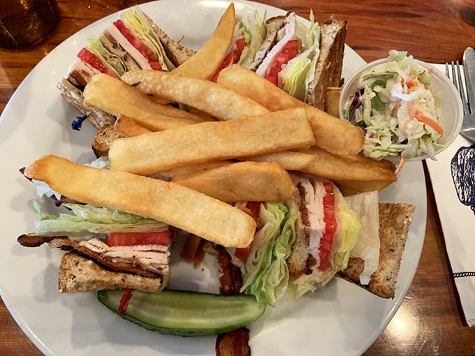 The club sandwich: architecture you can eat. Three stories of deliciousness with those fries standing at attention like tasty soldiers.