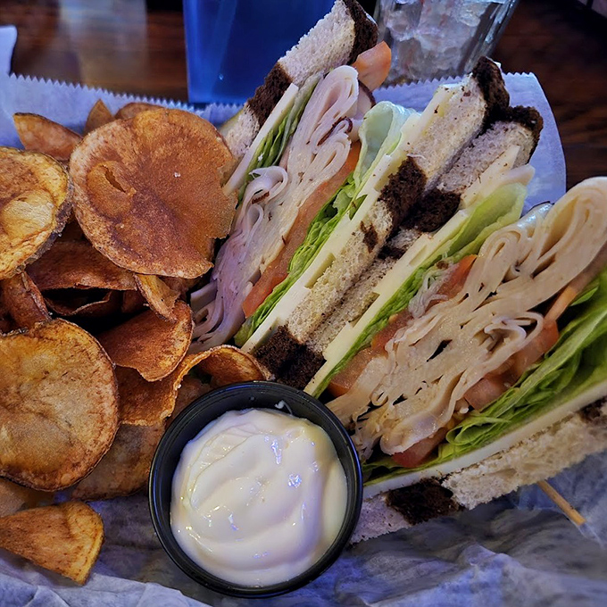 Club sandwiches are the unsung heroes of American cuisine, and this triple-decker beauty with its perfect toast lines proves why. Comfort food elevated to art form.