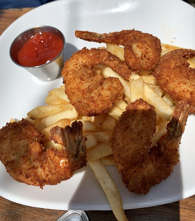 Coconut shrimp that would make even coconut-haters reconsider their life choices &ndash; crispy, sweet, and served atop perfectly cooked fries.