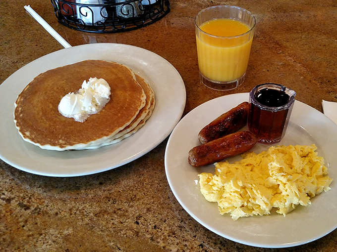 Pancakes so perfectly golden they could win medals, paired with eggs and sausage in breakfast's most iconic trio since bacon, lettuce, and tomato.