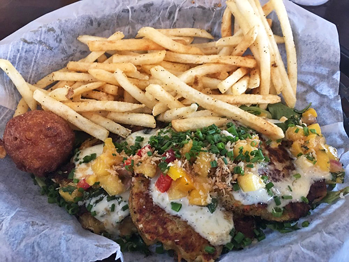 These golden crab cakes nestled beside perfectly crisp fries aren't just food; they're edible postcards from the Gulf of Mexico.