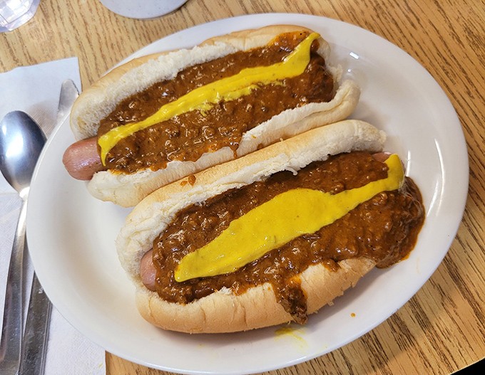 Two perfect coney dogs, where the mustard's yellow streak is like a racing stripe of flavor. Detroit's signature dish, served without pretense.