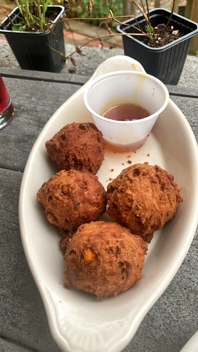 These corn fritters aren't just appetizers&mdash;they're golden orbs of happiness with a honey dipping sauce that makes grown adults contemplate licking the plate.