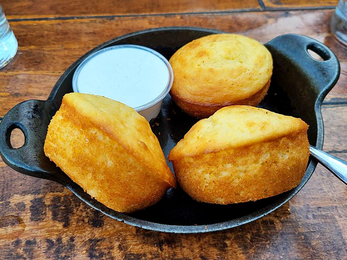 Golden cornbread that doesn't need your sympathy butter &ndash; it stands proud on its own merits while still graciously accepting a slather of honey butter.