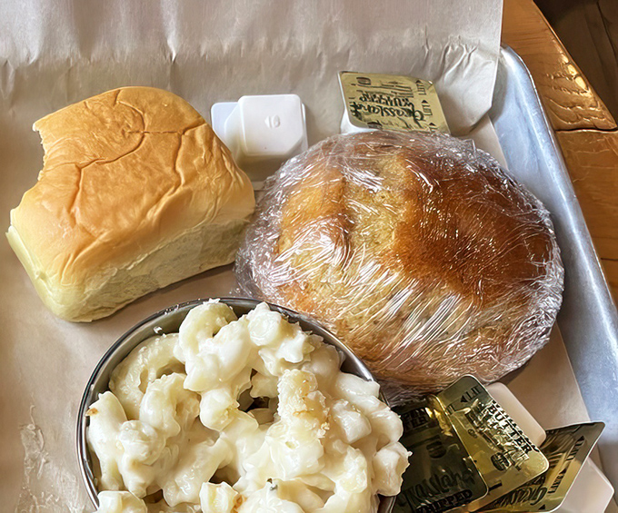 The holy trinity of barbecue accompaniments: soft roll, creamy mac and cheese, and cornbread that could make a Southerner weep with joy.