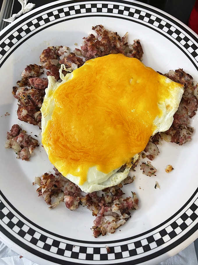 Crispy corned beef hash supporting a perfect sunny-side-up egg &ndash; a relationship more supportive than most marriages I know. 