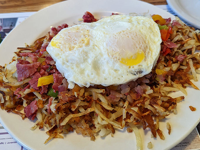 Corned beef hash crowned with a sunny-side-up egg &ndash; breakfast royalty that turns ordinary mornings into occasions worth getting out of bed for. 