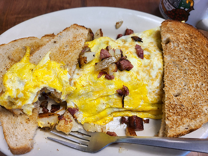 This isn't just an omelet—it's a masterclass in egg architecture with perfectly distributed corned beef in every heavenly bite.