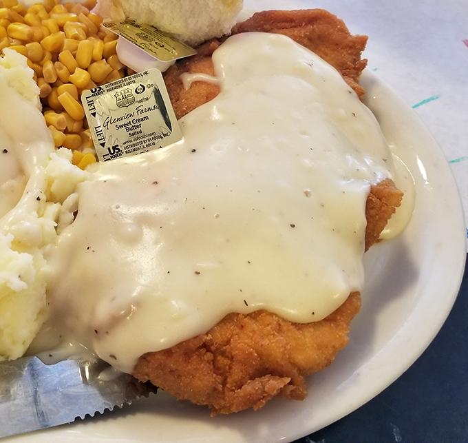 Country fried steak smothered in gravy that would make your grandmother proud. Comfort food that demands both a knife and a nap afterward.