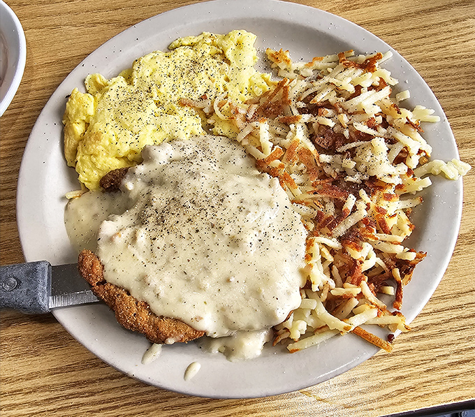 Country-fried steak smothered in gravy with hash browns crispy enough to make a potato proud &ndash; comfort food that hugs you from the inside. 