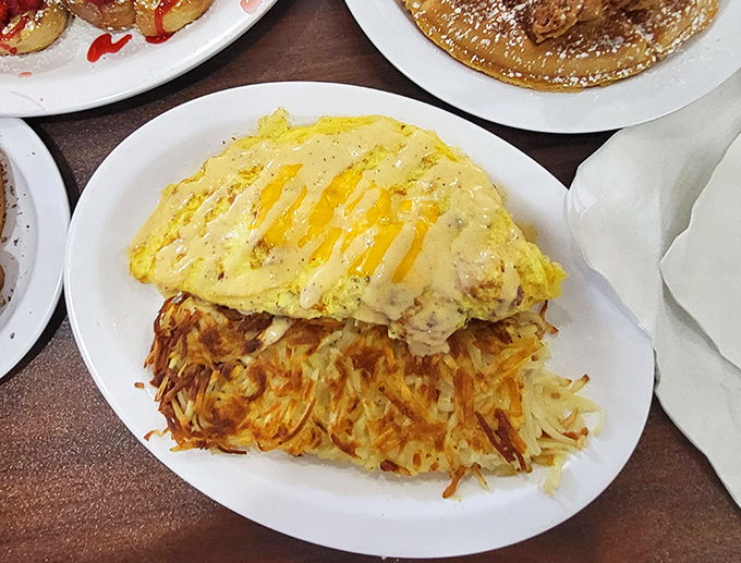 This omelet doesn't just sit on the plate&mdash;it commands it, with hash browns crisped to the exact point where potato meets magic.