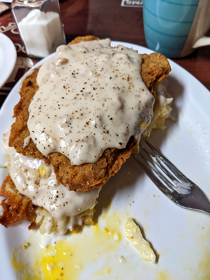 Country fried steak smothered in peppery gravy—the kind of breakfast that makes you wonder why anyone would ever settle for a protein bar.