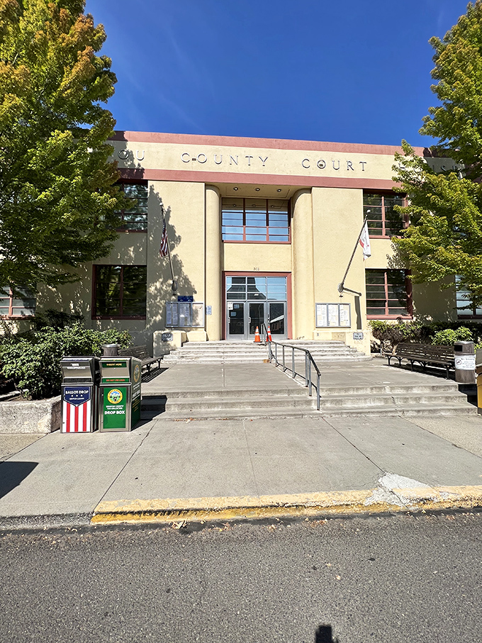 Yreka's Art Deco County Court building stands as a testament to civic pride and architectural flair, framed by trees that have witnessed decades of local history.