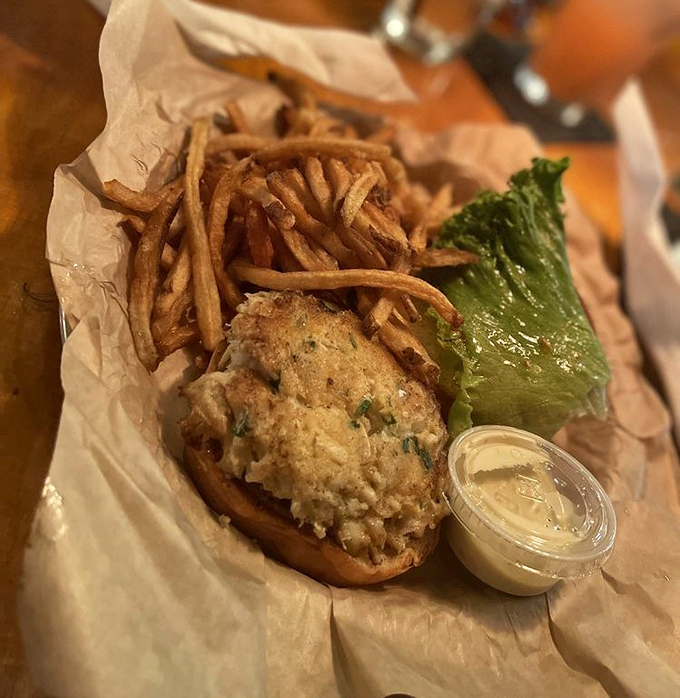 The crab cake sandwich&mdash;where Maryland tradition meets Norfolk hospitality. That golden-brown patty practically whispers "I'm mostly crab, not filler" with every bite.